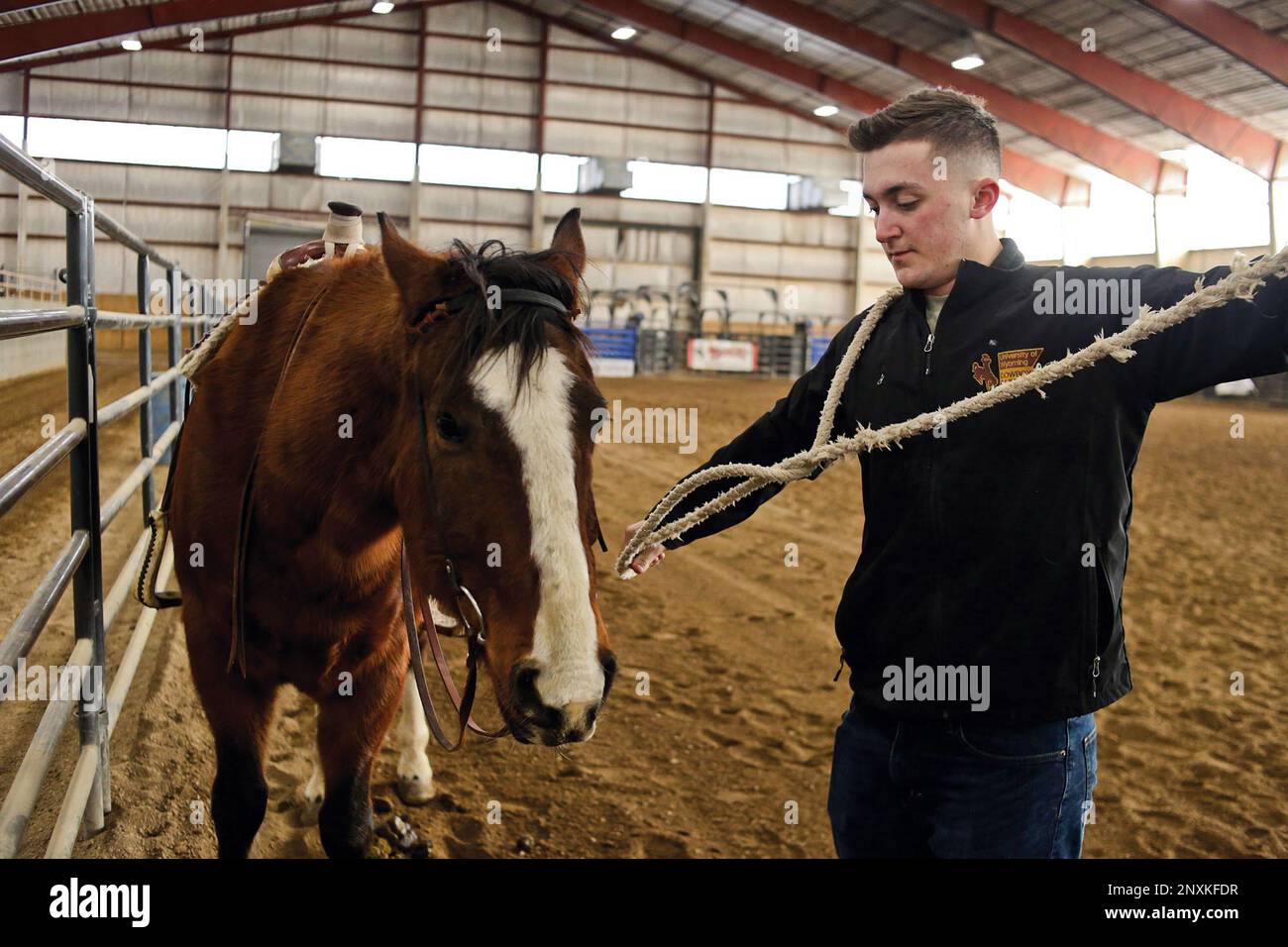 University of Wyoming sophomore Cody Vincent prepares to mount his ...
