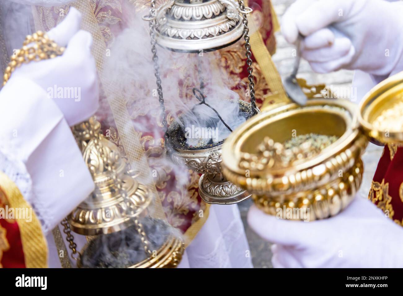 Detail of the hand of an altar boy or acolyte in a Holy Week procession ...