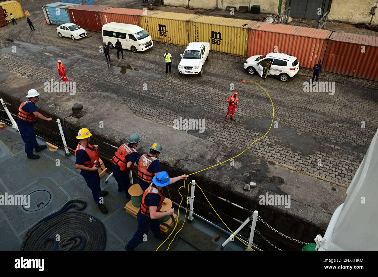 U.S. Coast Guard Seaman Brock Richards throws a heaving line as USCGC ...