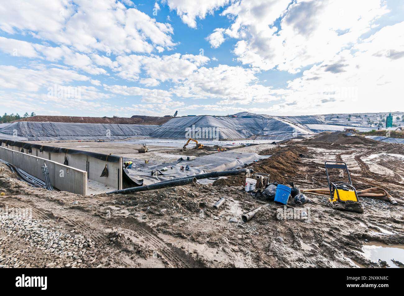 A concrete box culvert with a geomembrane covering and stabilizing ...