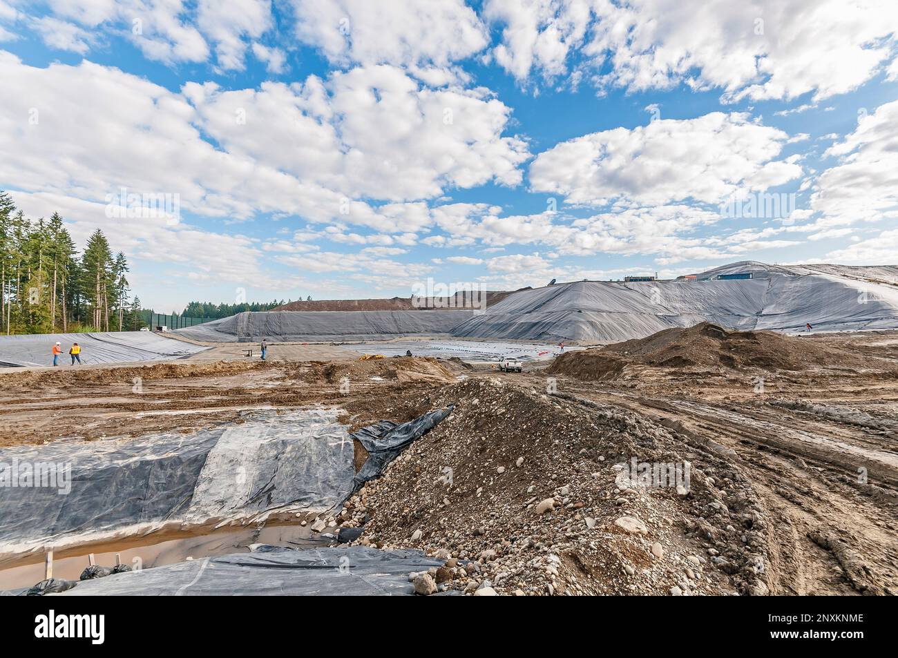 Vast areas of excavation and plastic geomembrane coverings at an active ...