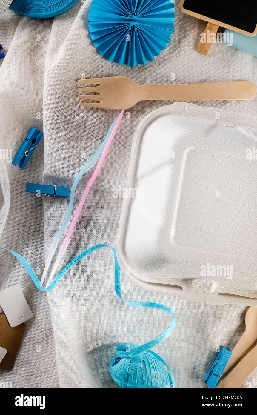 Closed bento cake box with a wooden spoon and blue ribbon. Gift box ...