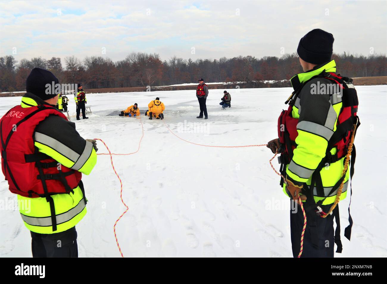 Firefighters wearing cold-water immersion protective suits hold surface ...