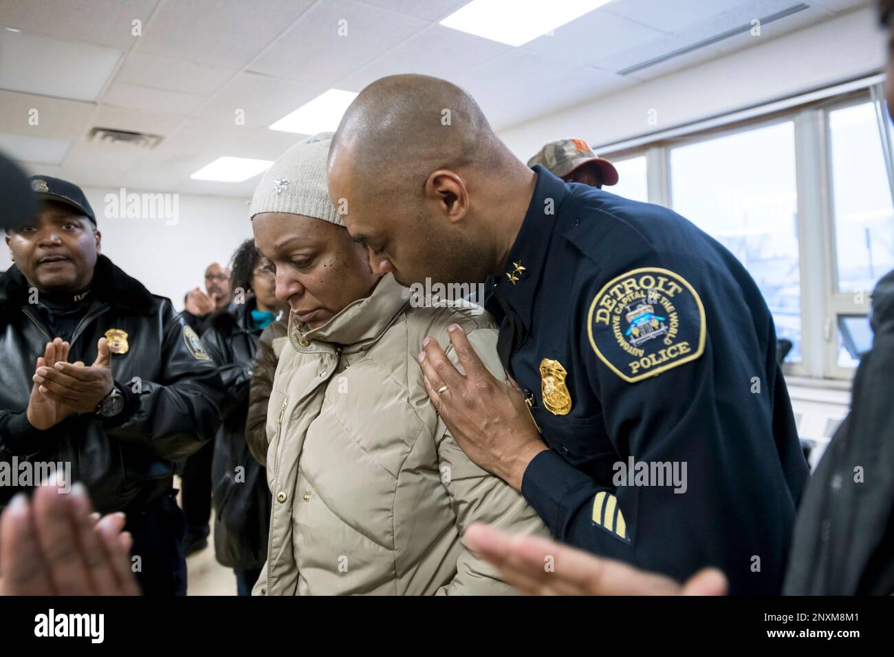 Detroit Police Commander Charles Mahone embraces Nikole Flowers, mother ...