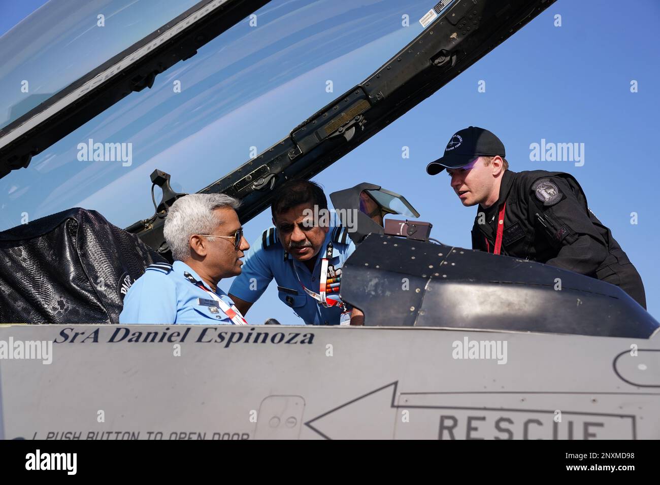 Members of the Indian Air Force are shown a U.S. Air Force F-16 Fighting Falcon by a member of ...