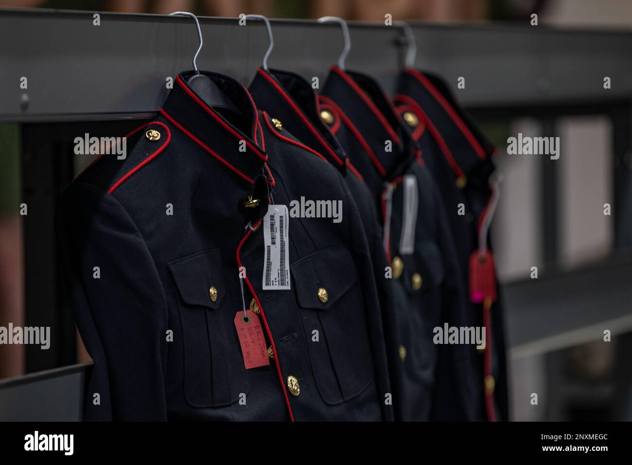 U.S. Marine Corps Dress Blue coats are hung in preparation to be ...