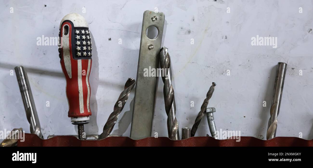 tools in the workshop drills, screwdrivers, scissors on the metal Stock ...
