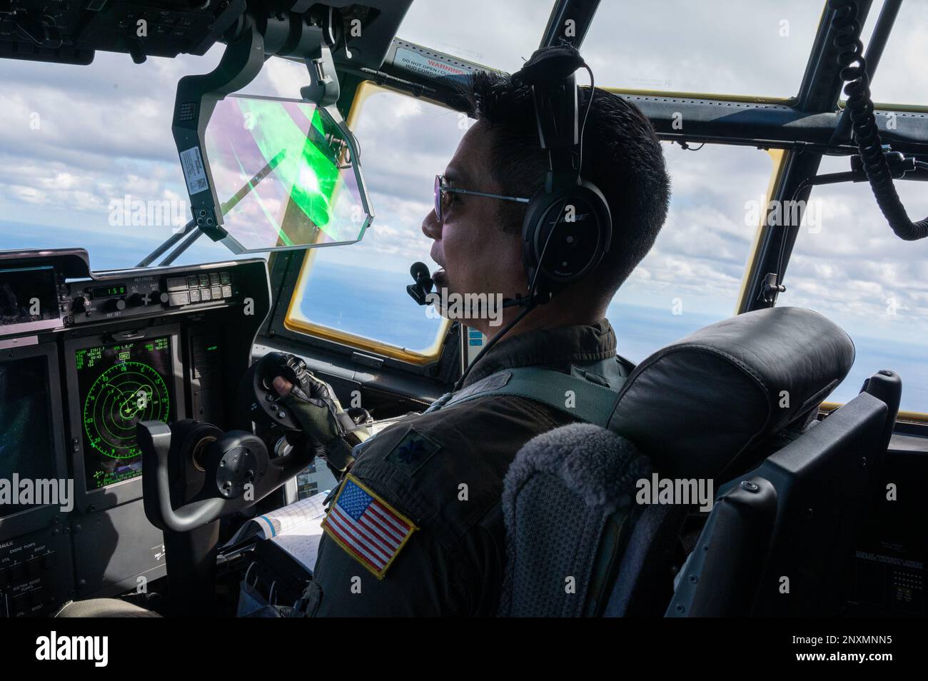 Lt. Col. Chris Ferrara, 39th Rescue Squadron pilot, scans the ocean as ...