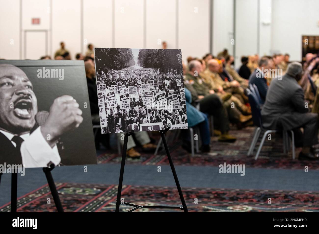 Photos from the civil rights era are placed for the audience to see ...