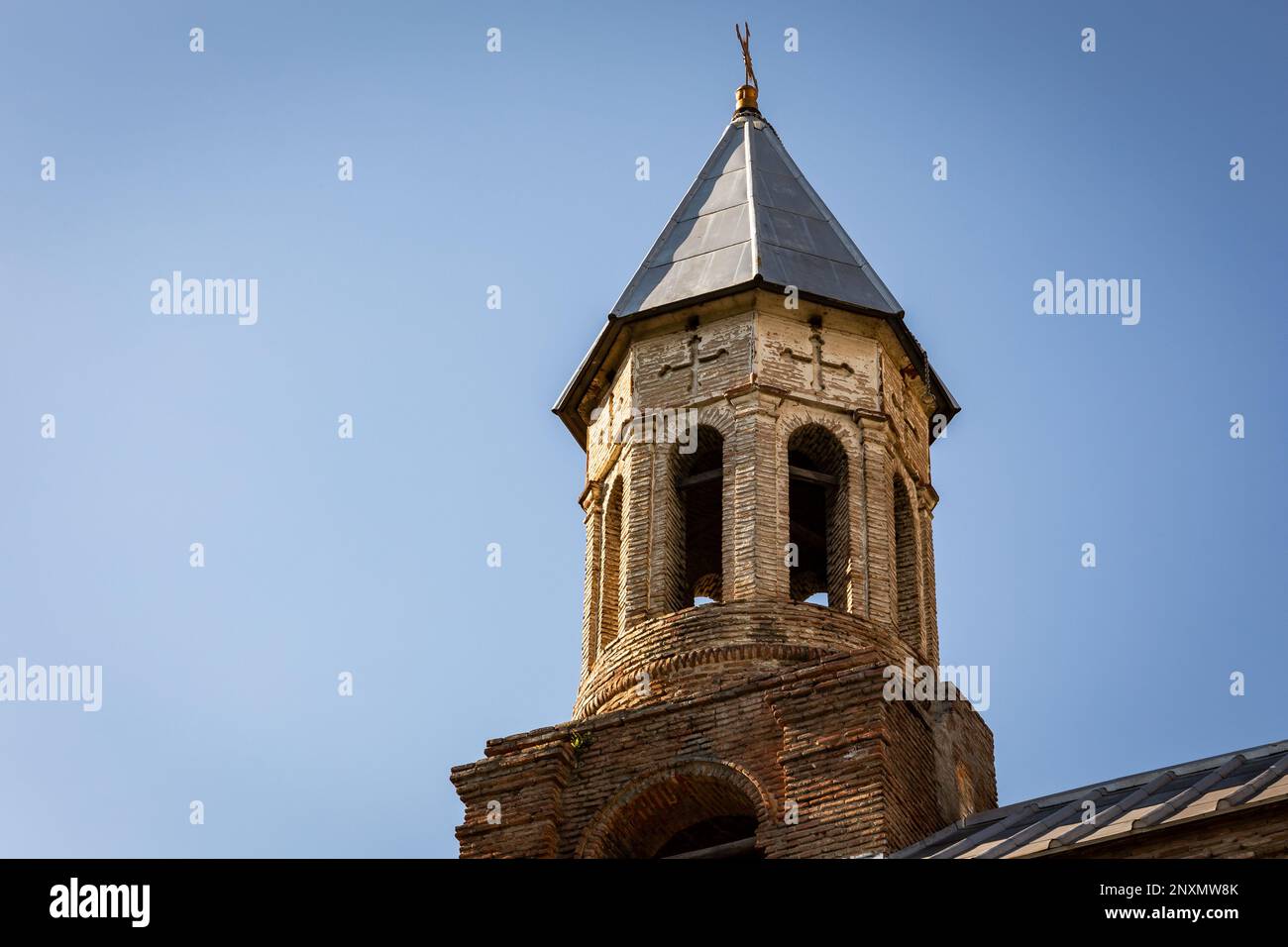 Old medieval bell tower (belfry) against blue sky, Church of Saint ...