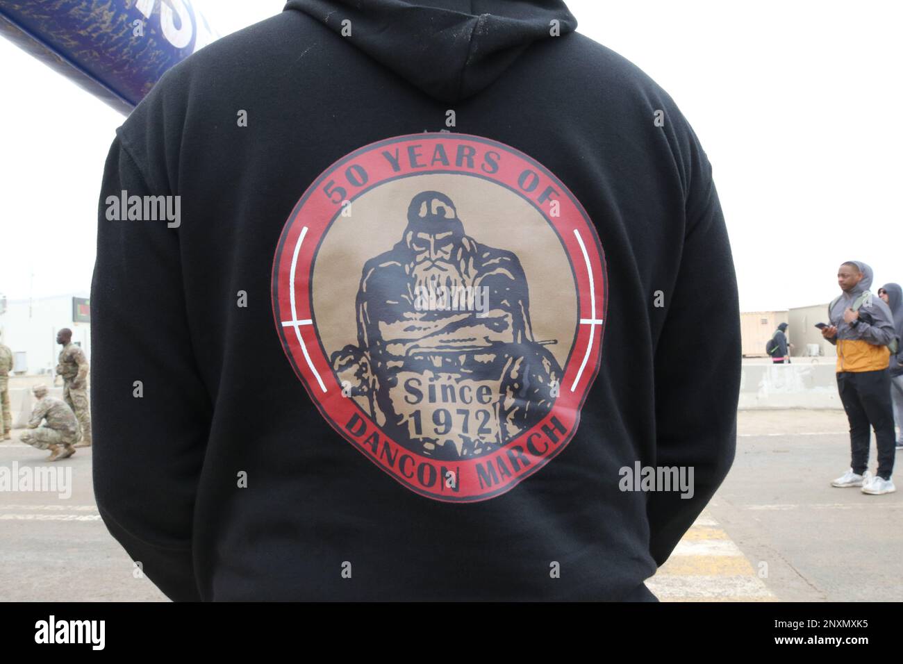 A volunteer wears a 50th Anniversary commemorative sweatshirt during ...