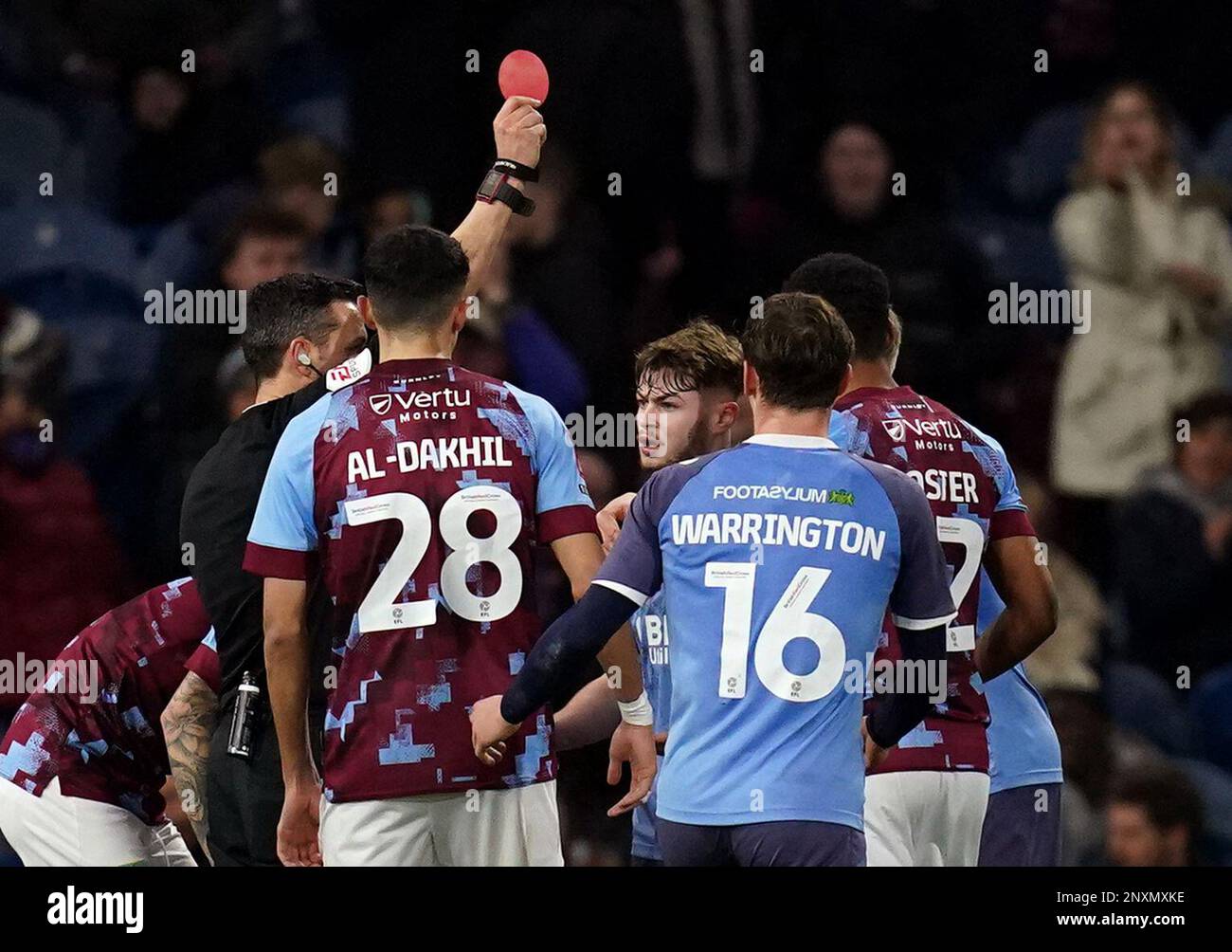 Fleetwood Town's Cian Hayes (centre) is shown a red card by referee ...