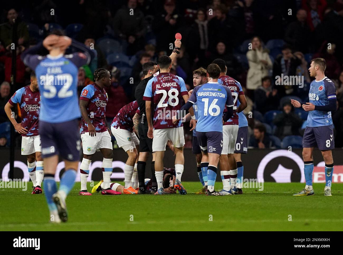Fleetwood Town's Cian Hayes (centre) is shown a red card by referee ...