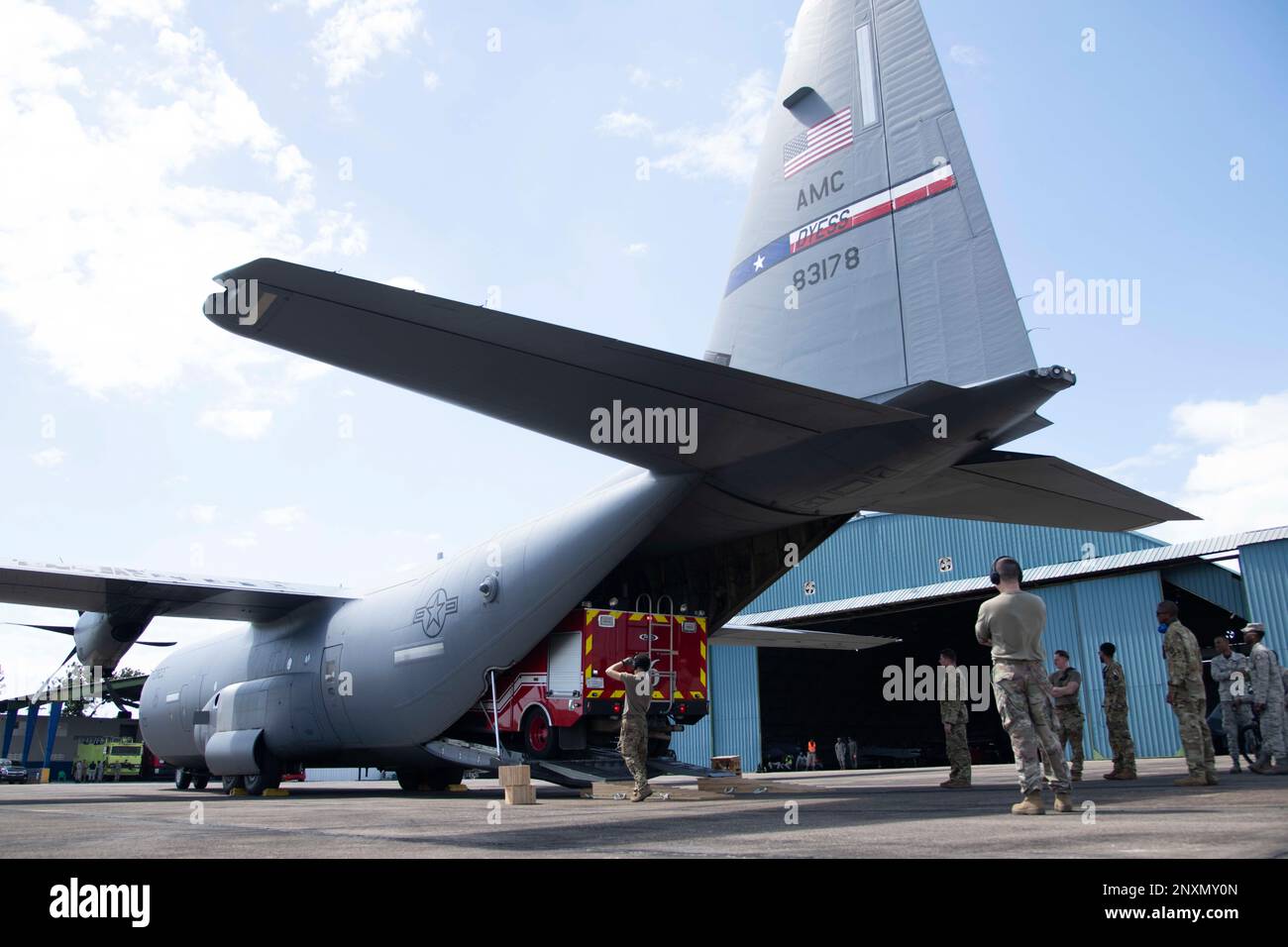 U.S. Airmen unload a P-34 Rapid Intervention Vehicle from a C-130J ...