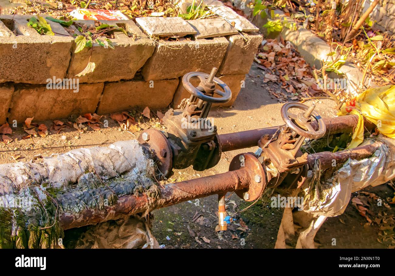 Old rusty faucet for hot water supply and water supply pipes. Thermal ...