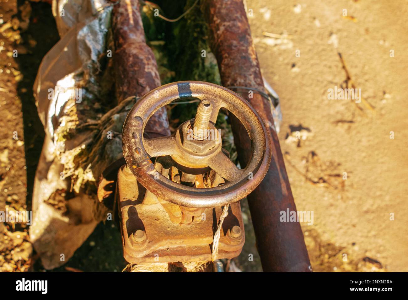 Old rusty faucet for hot water supply and water supply pipes. Thermal ...