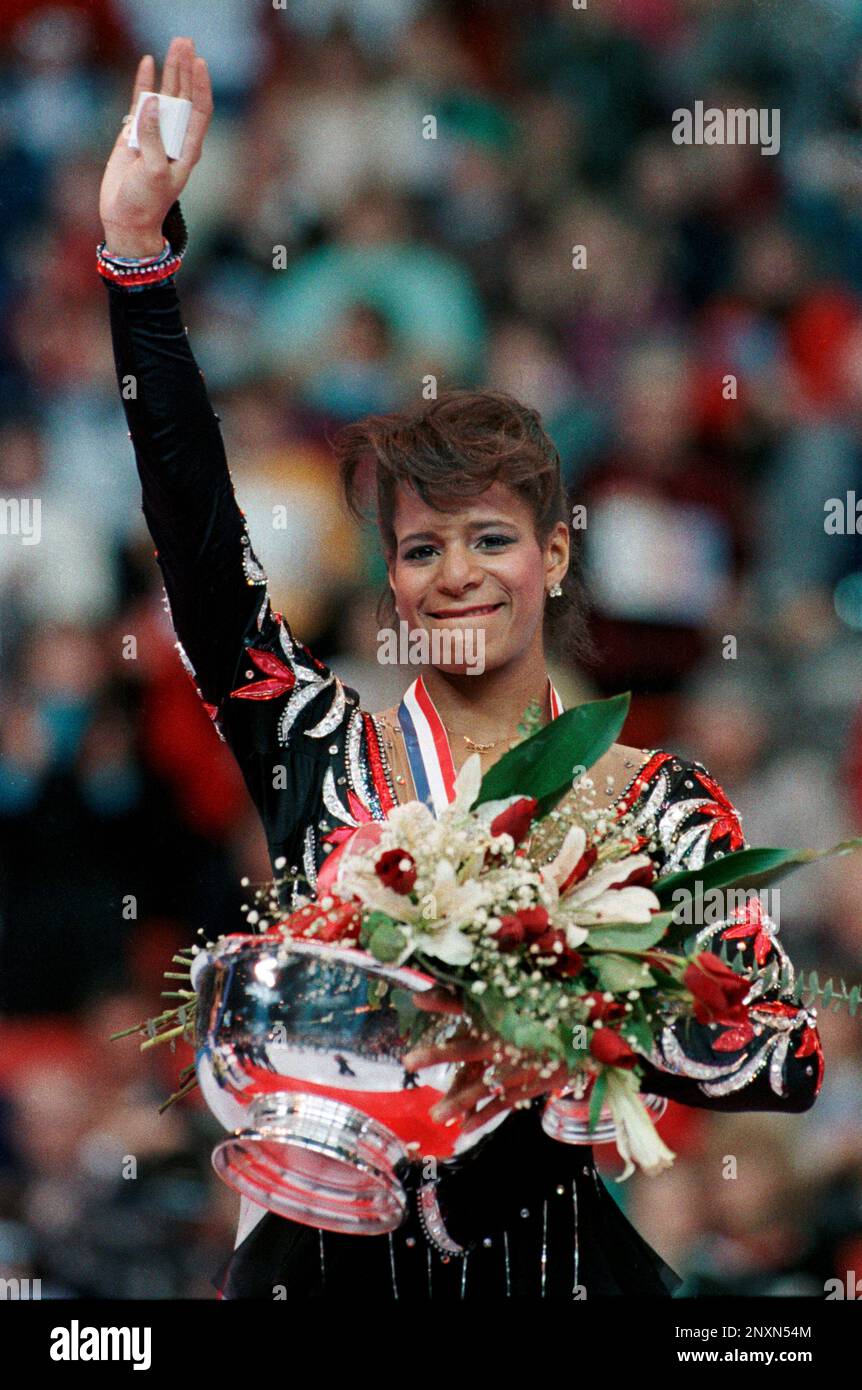 Debi Thomas waves to the crowd after being presented with the gold ...