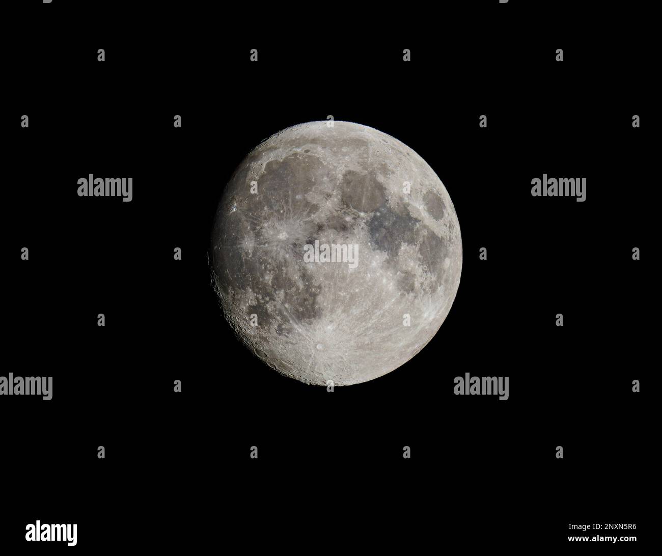 The waning moon in the early morning in april Stock Photo - Alamy