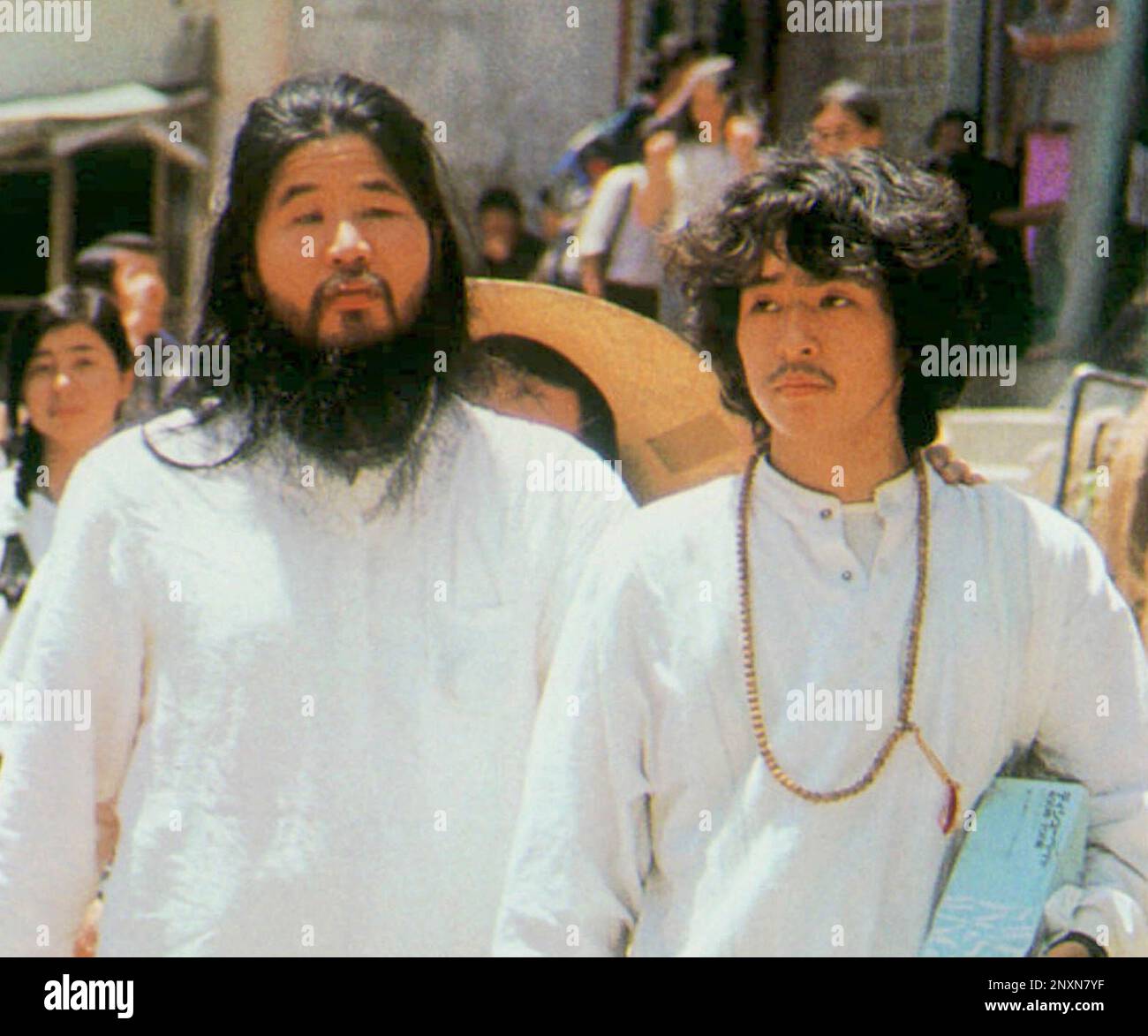 FILE - In this undated file photo, cult guru Shoko Asahara, left, of Aum Shinrikyo walks with ...