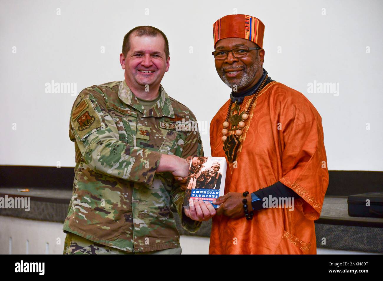 Col. Michael Cabral, 926th Wing vice wing commander, holds up a book ...