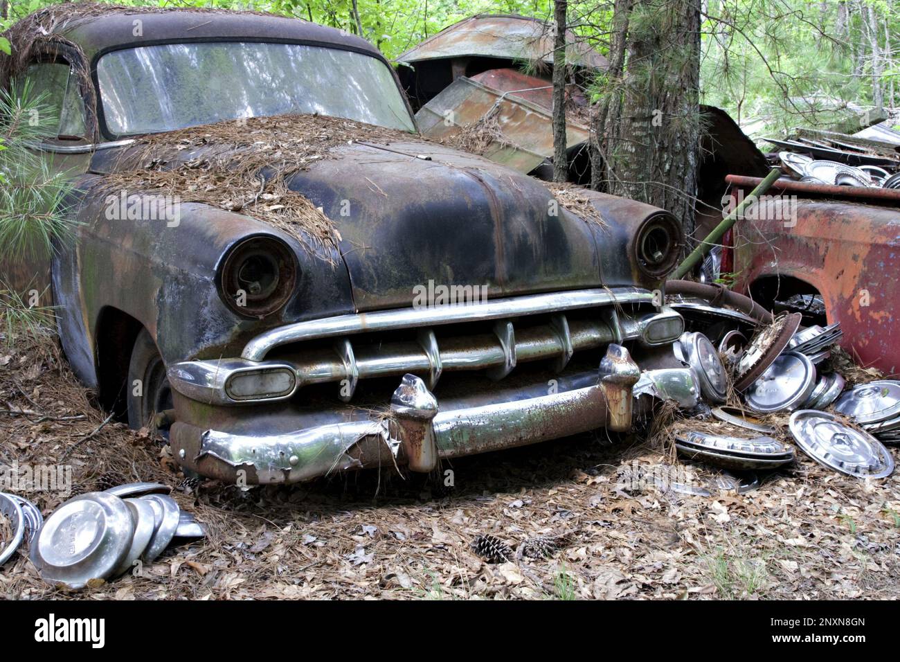 Old classic American car in a scrap yard Stock Photo - Alamy