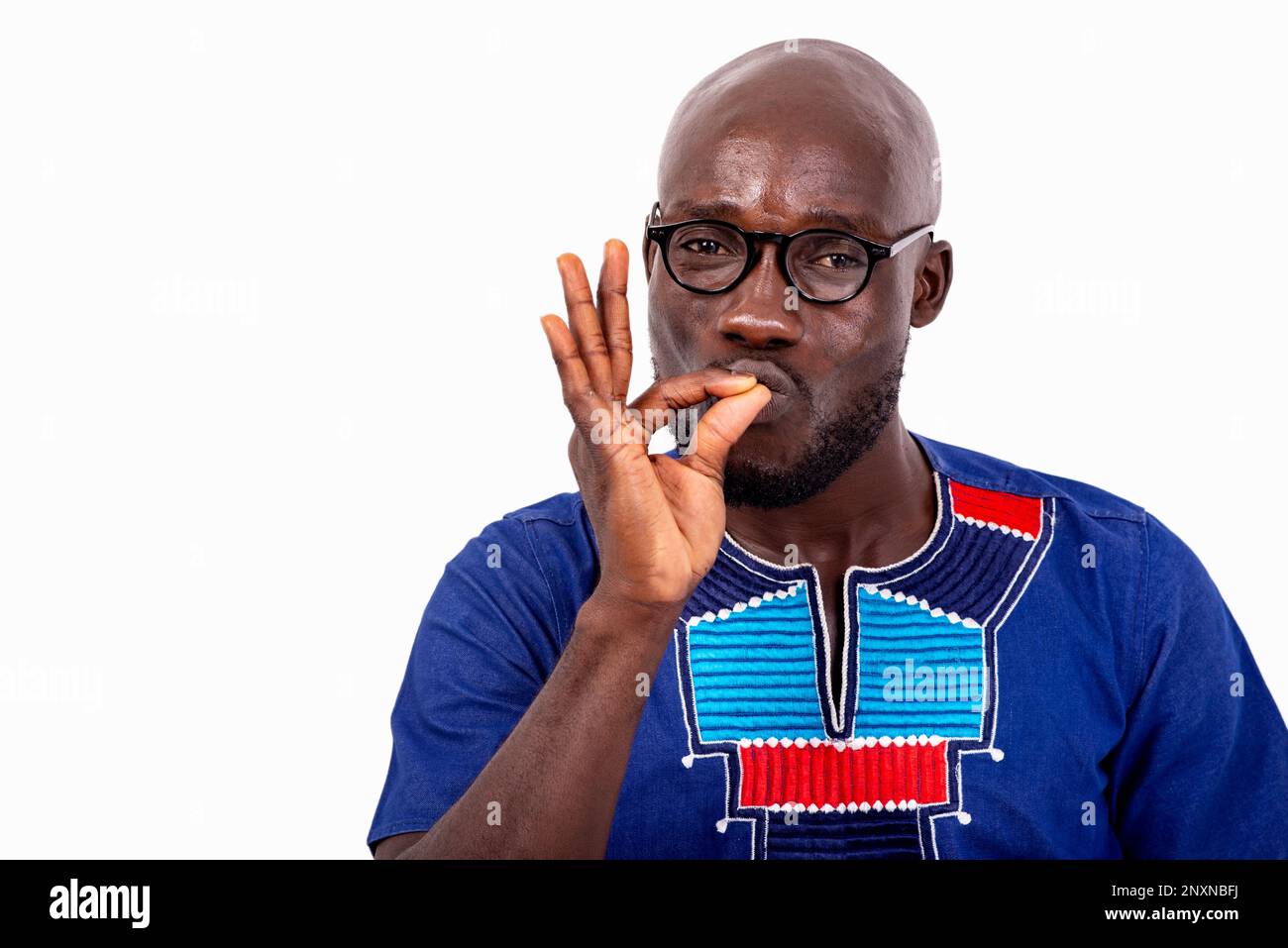 portrait of young young man showing delicious sign of taste with hand ...