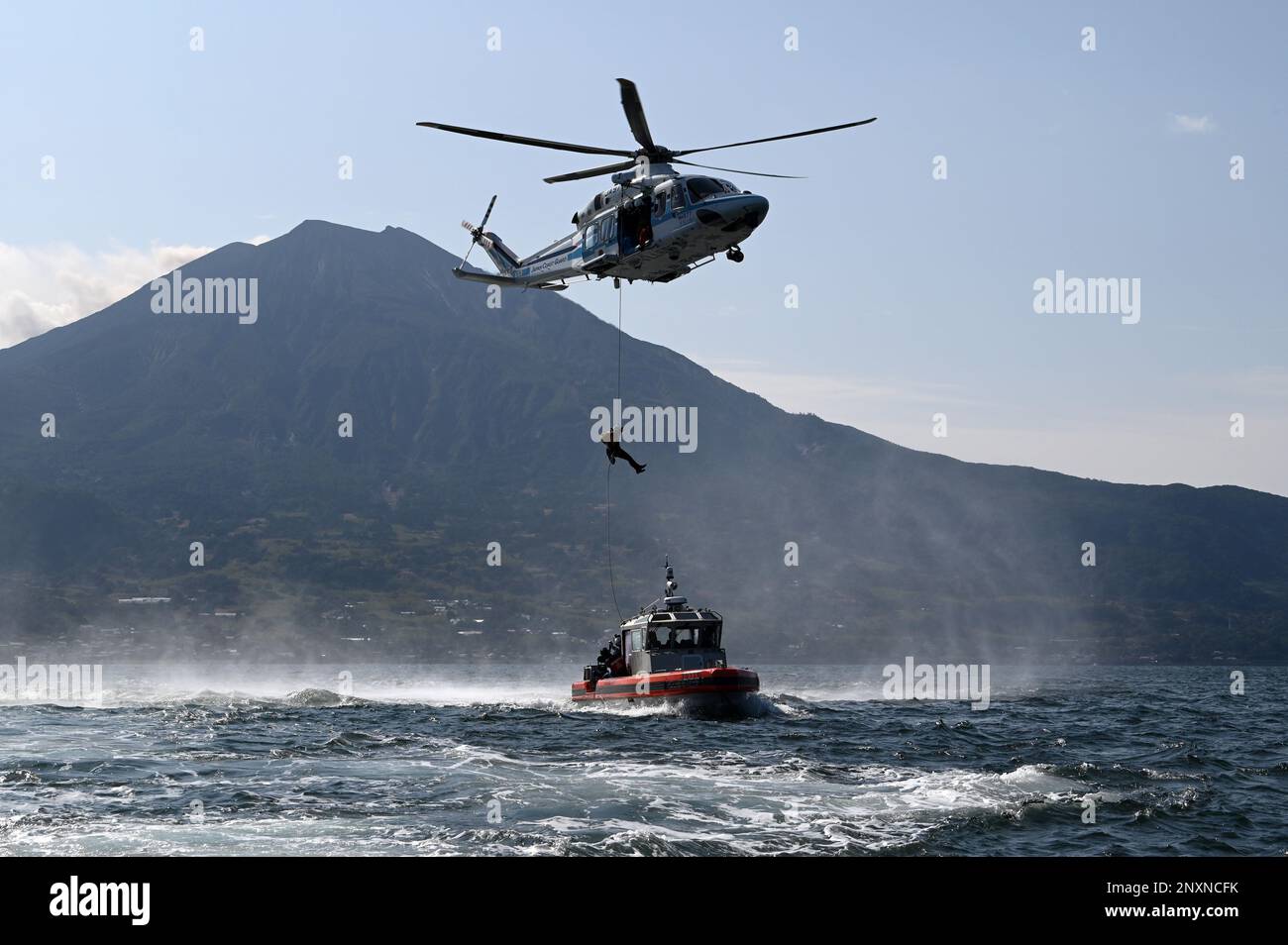 A Japan Coast Guard Mobile Rescue Technician repels from a Japan Coast ...