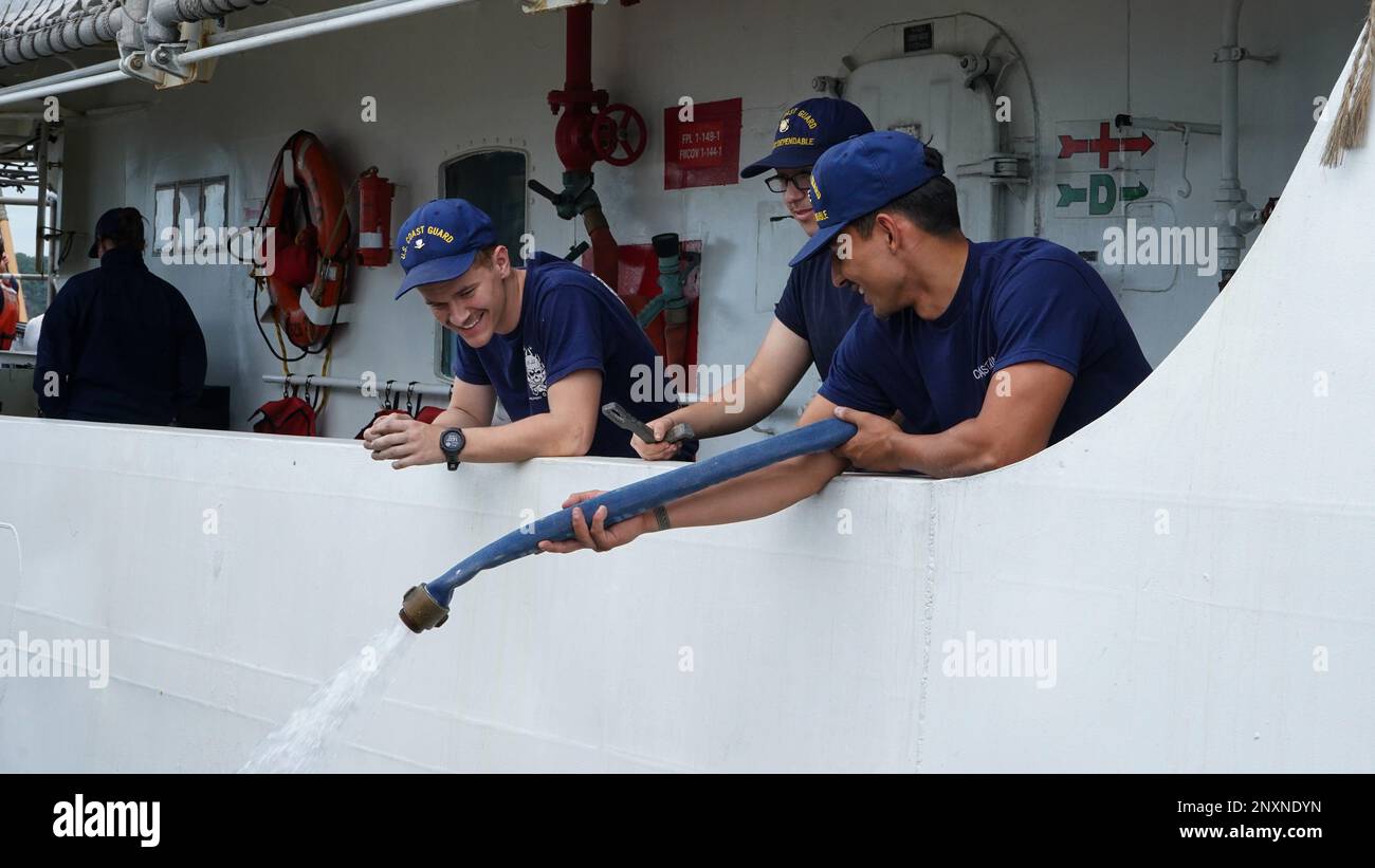 Crew members assigned to USCGC Dependable (WMEC 626) assist with the ...
