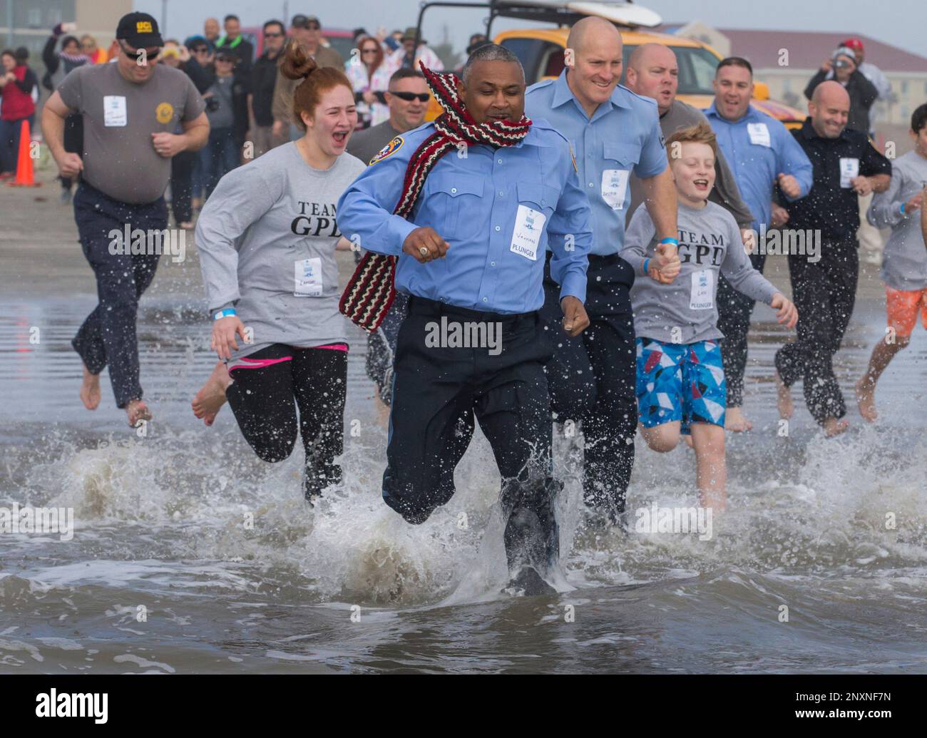 Galveston Police Chief Vernon Hale runs into the water during the ...