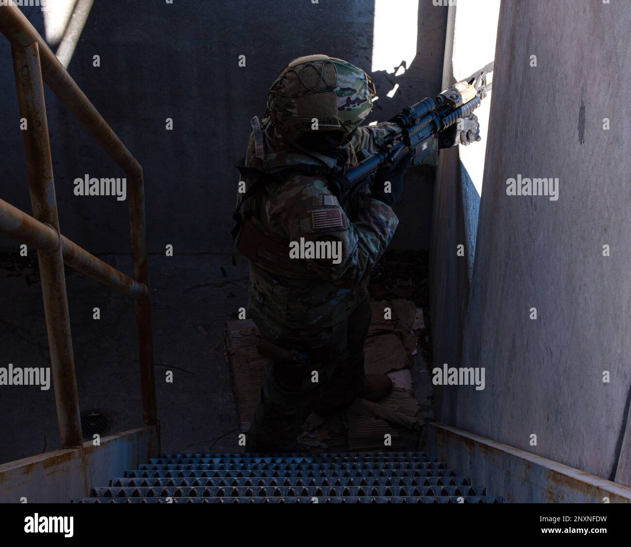 An Airman from the 22nd Security Forces Squadron guards a window while ...