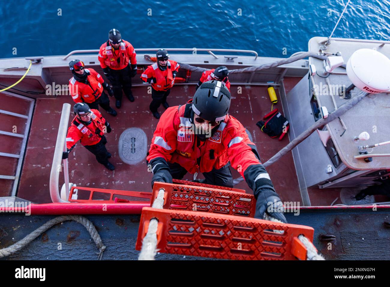 Coast Guardsmen on Coast Guard Cutter Polar Star (WAGB 10), climb down ...