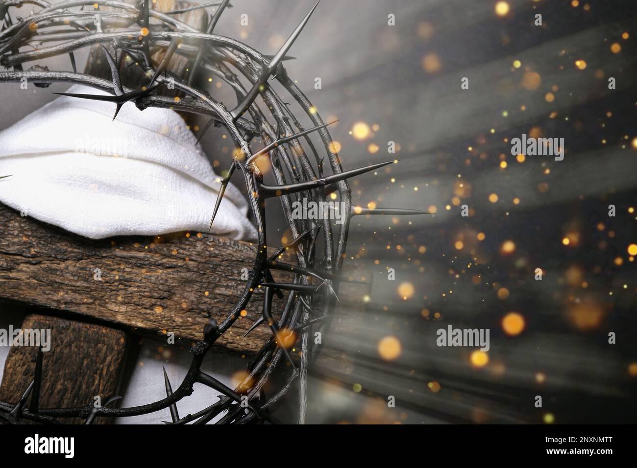 Crown of thorns, wooden cross and shroud on dark background, closeup ...