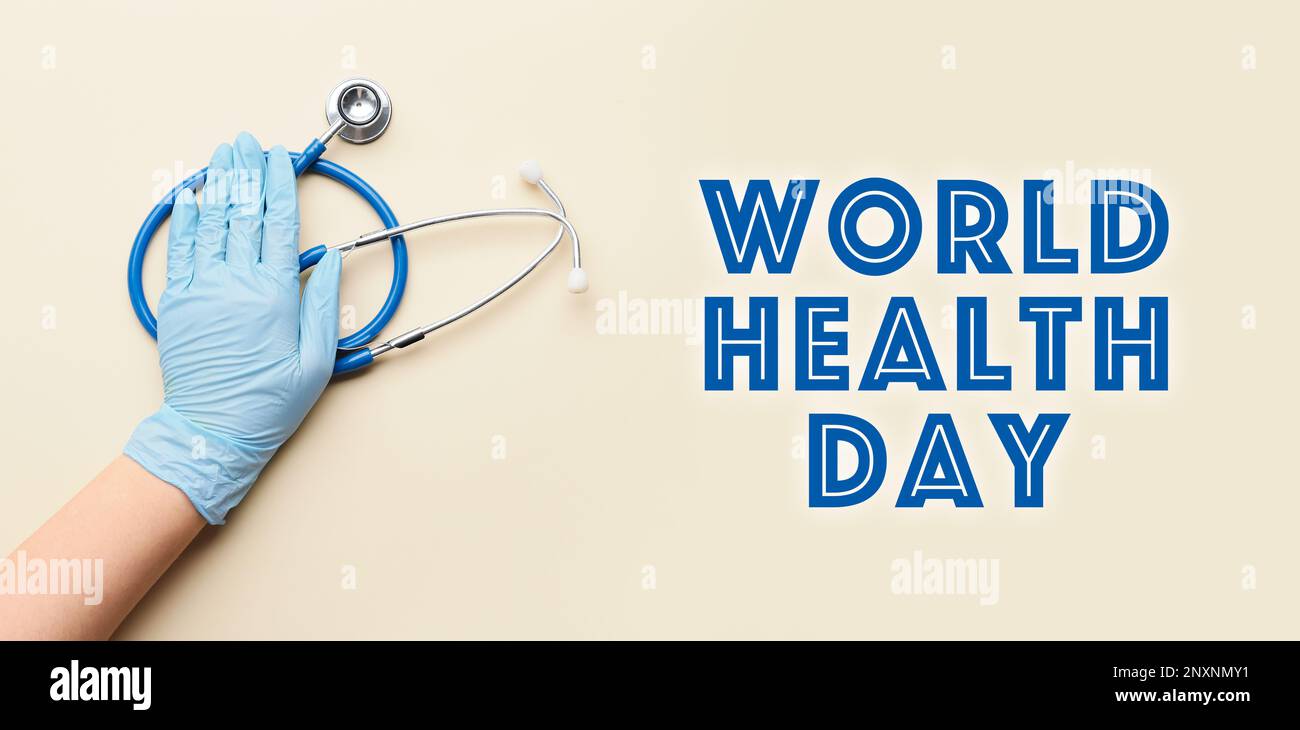 Hand of doctor with stethoscope on beige background. World Health Day ...