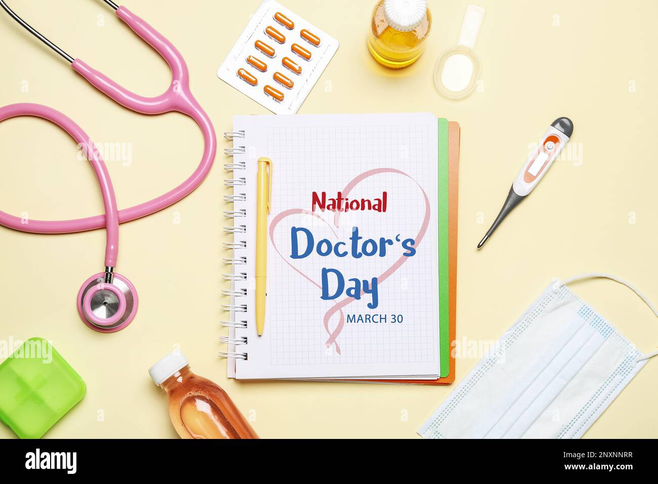 Notebook with text NATIONAL DOCTORS DAY, stethoscope, medical mask and ...