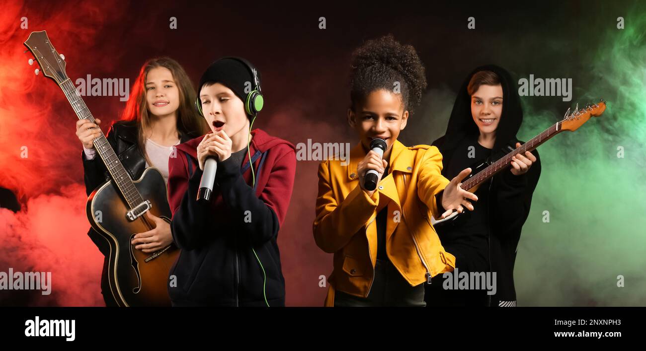 Band of teenage musicians on dark background Stock Photo - Alamy