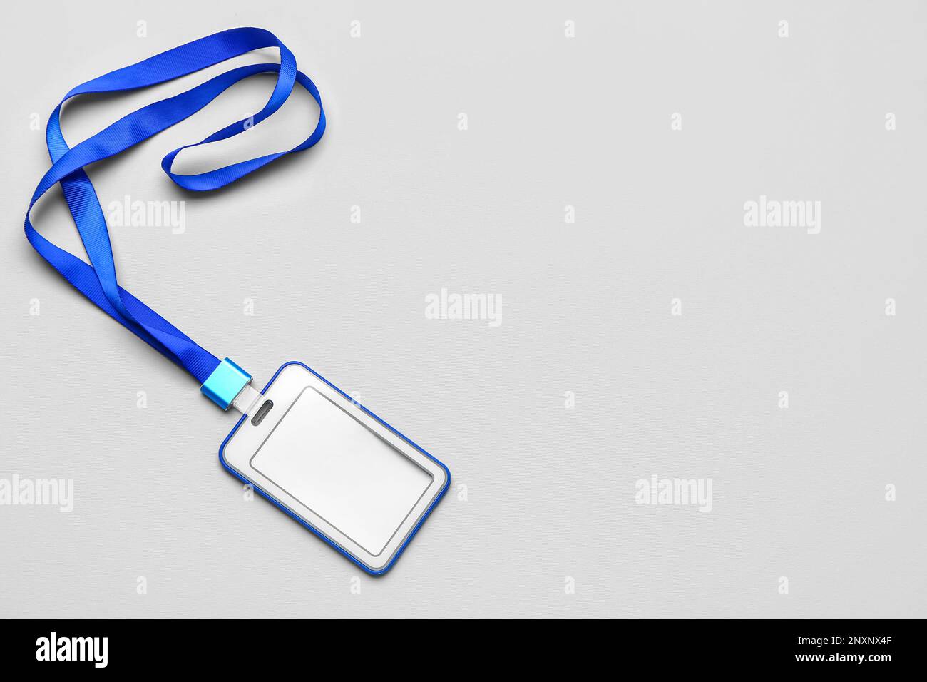 Blank badge with blue lanyard on light background Stock Photo - Alamy