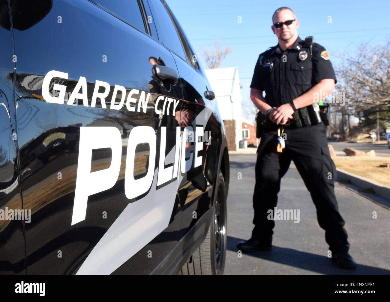 A reflection catches Garden City Police Chief Jeremy Black as he stands ...