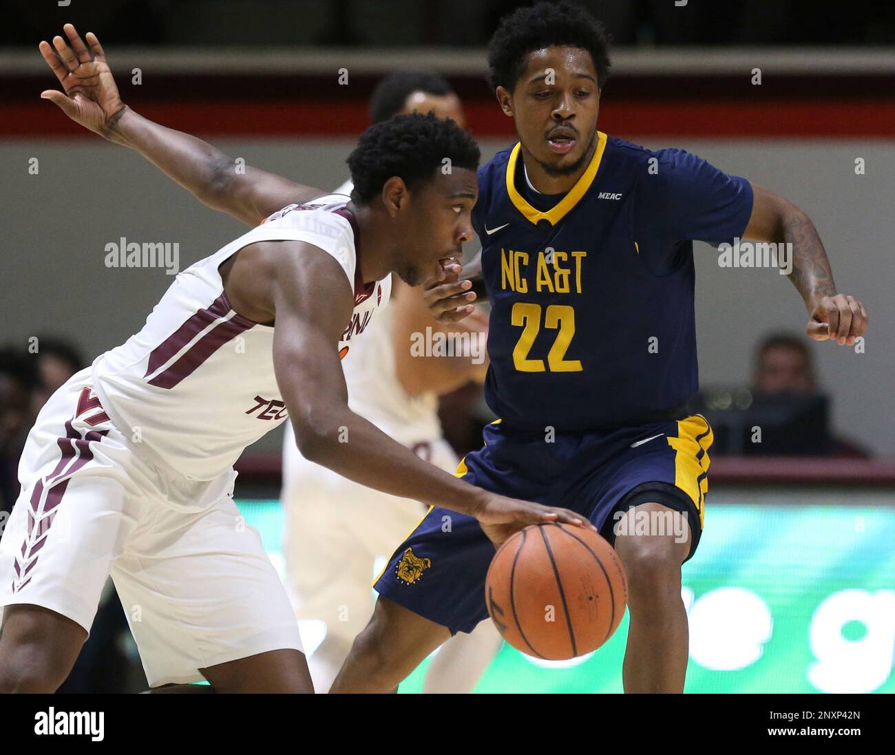 Justin Bibbs (10) left, of Virginia Tech drives on Milik Gantz (22) in ...