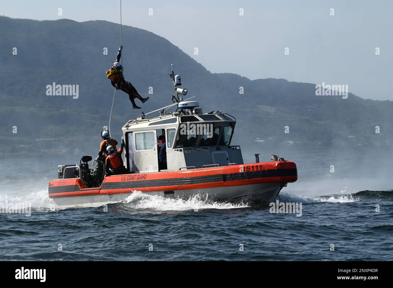A Japan Coast Guard Mobile Rescue Technician repels from a Japan Coast ...