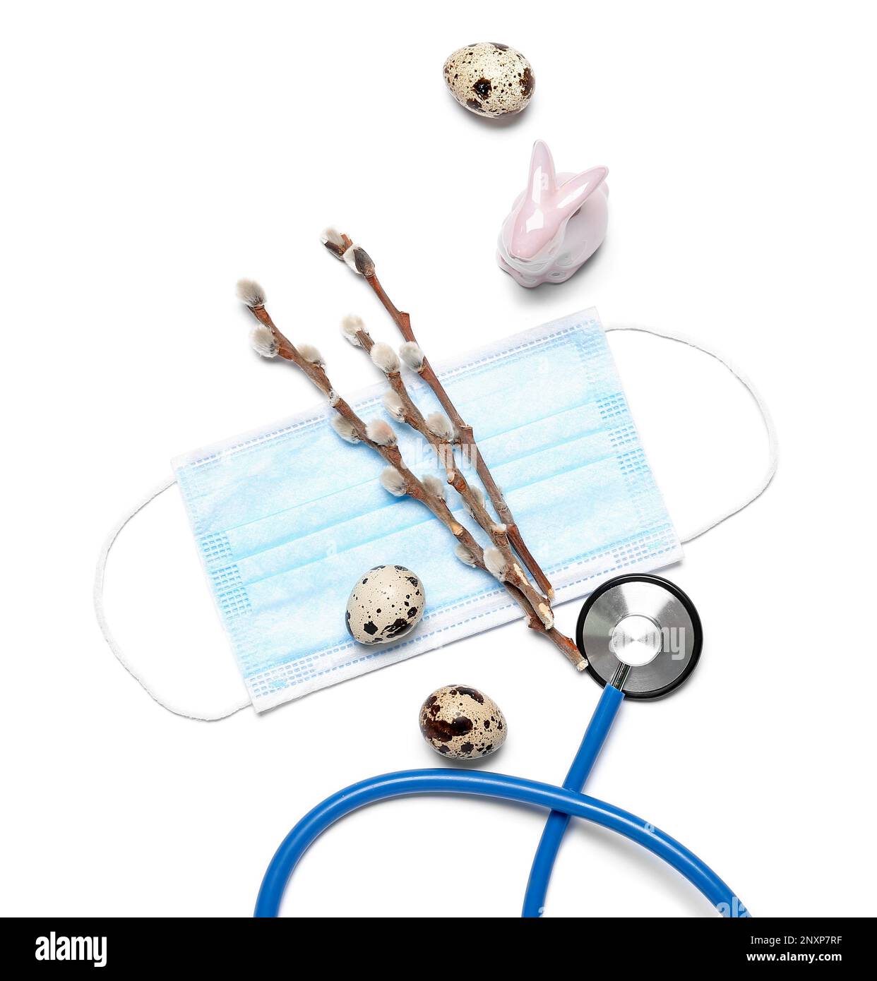Medical mask with willow branches, Easter eggs and stethoscope on white ...