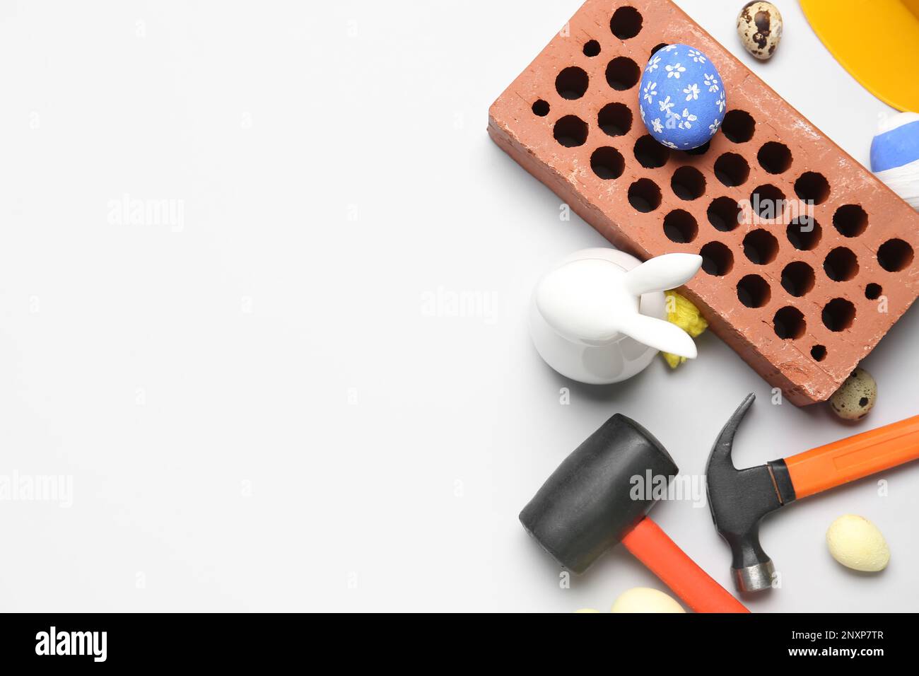 Easter rabbit with eggs and builder's tools on white background Stock ...
