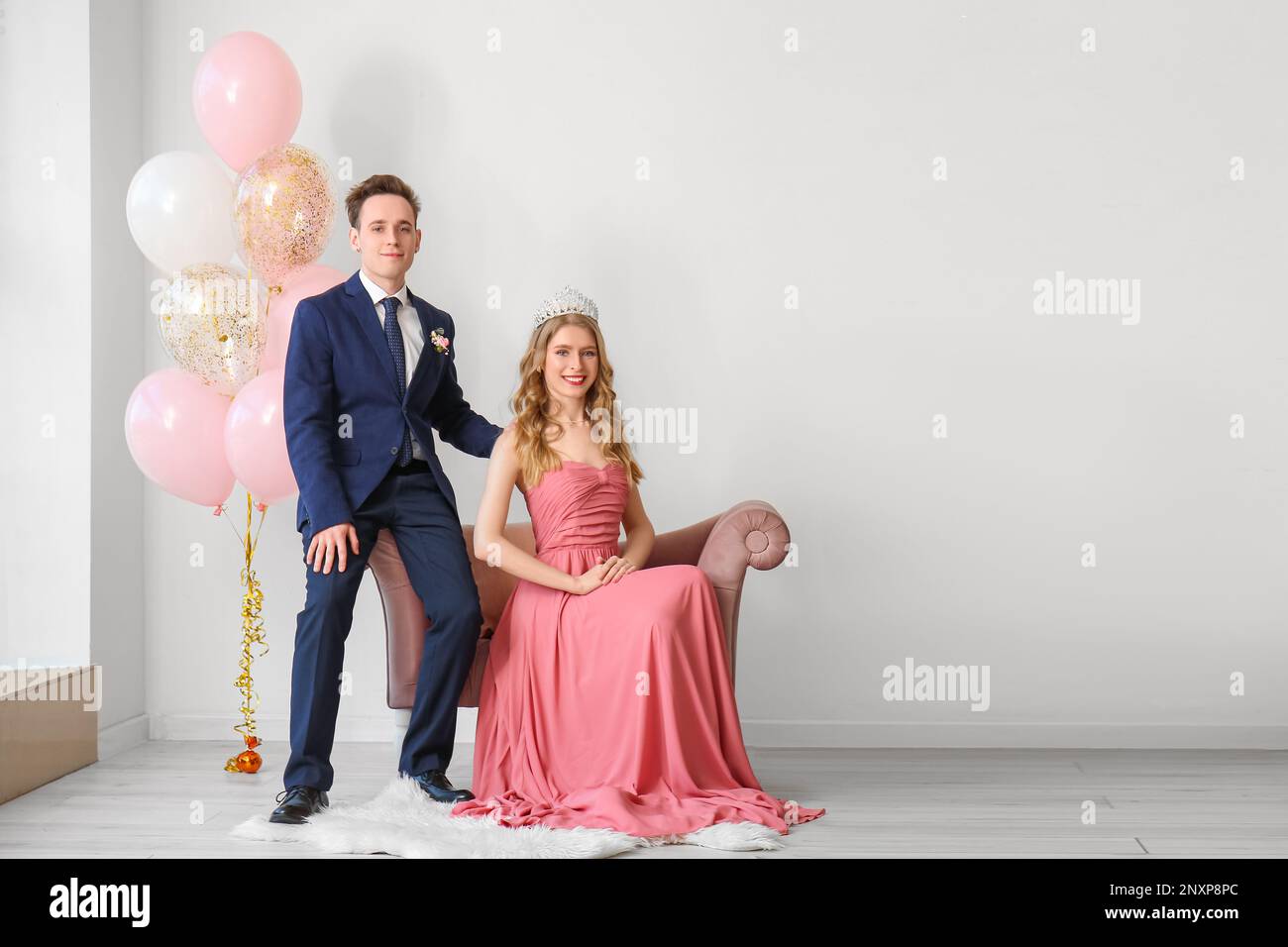 Beautiful couple dressed for prom in room Stock Photo - Alamy