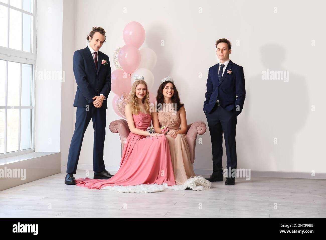 Beautiful couples dressed for prom in room Stock Photo - Alamy