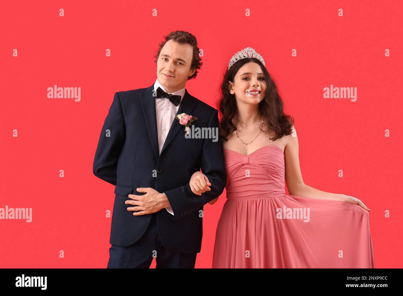Beautiful couple dressed for prom on red background Stock Photo - Alamy