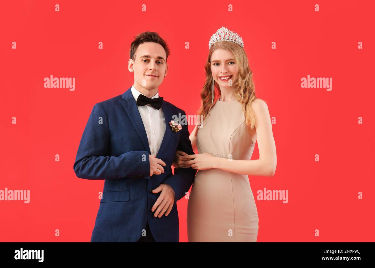 Beautiful couple dressed for prom on red background Stock Photo - Alamy