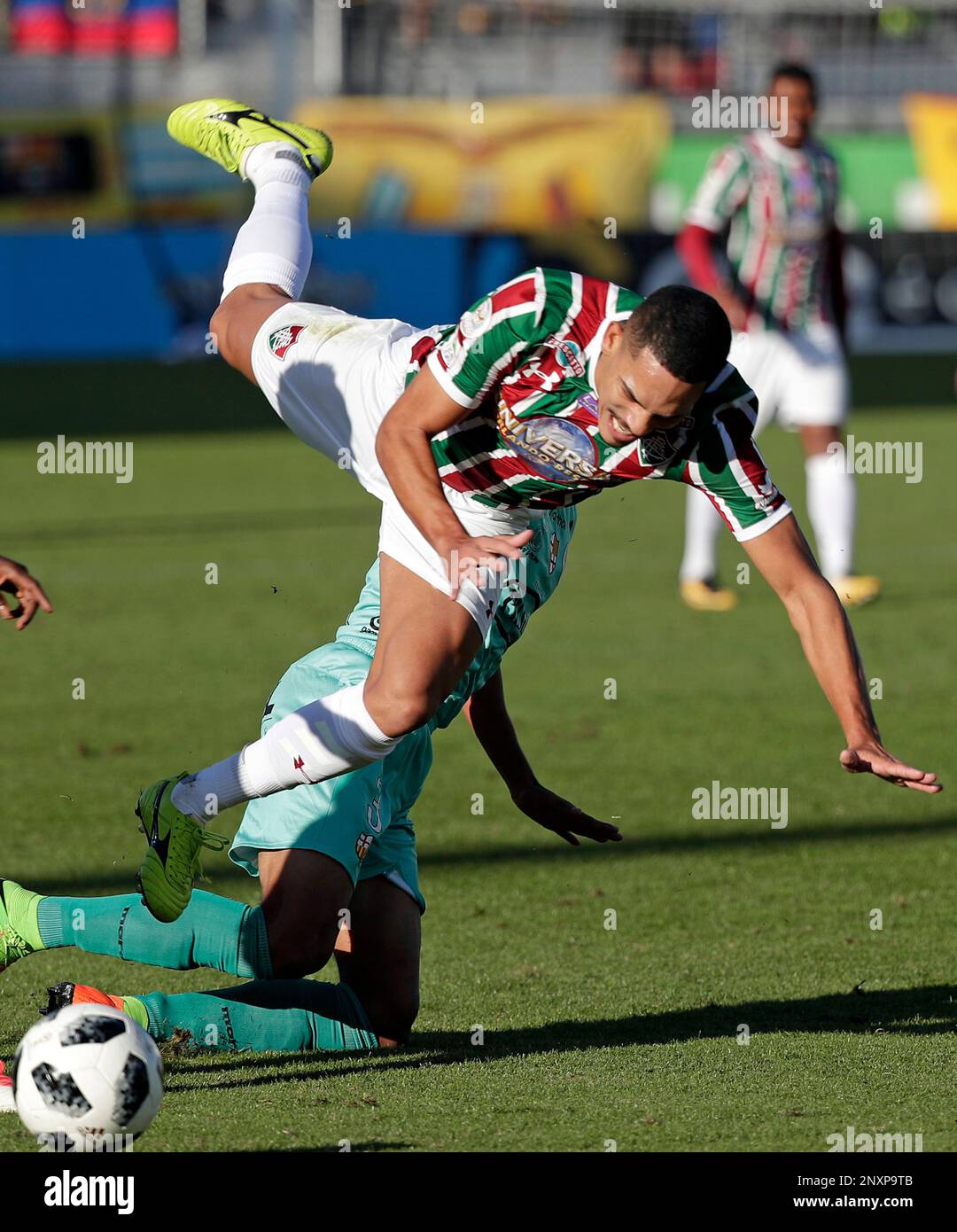Brazil's Fluminense's Gilberto, top right, flips over defender Ecuador ...
