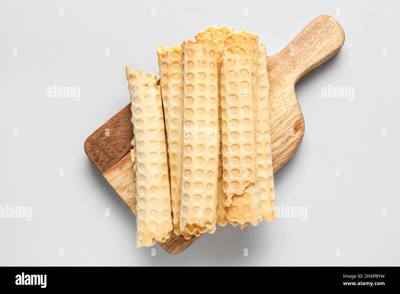 Board with delicious wafer rolls on grey background Stock Photo - Alamy