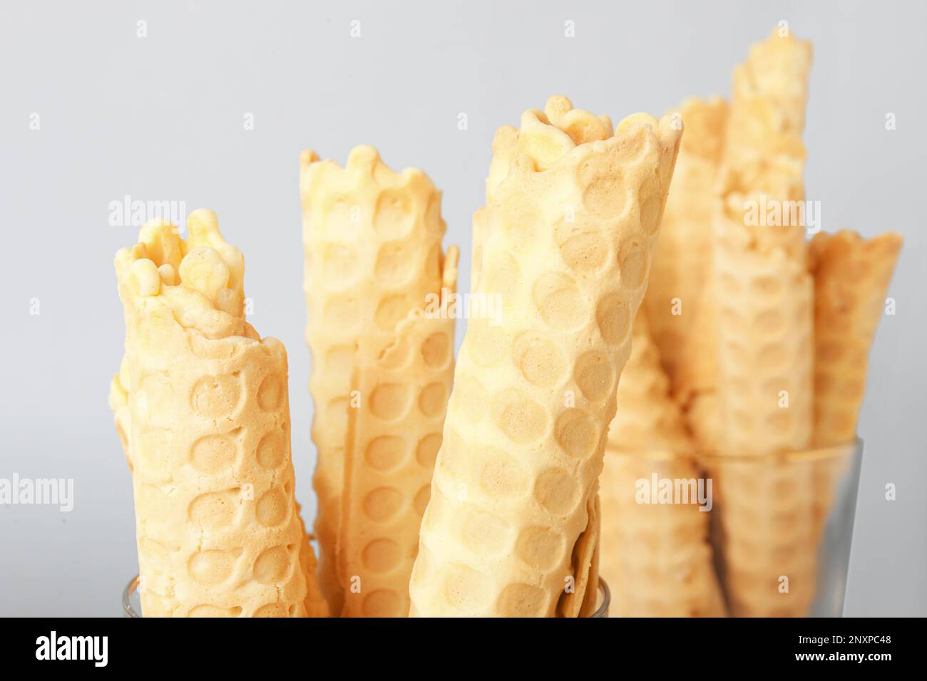 Delicious wafer rolls on grey background Stock Photo - Alamy