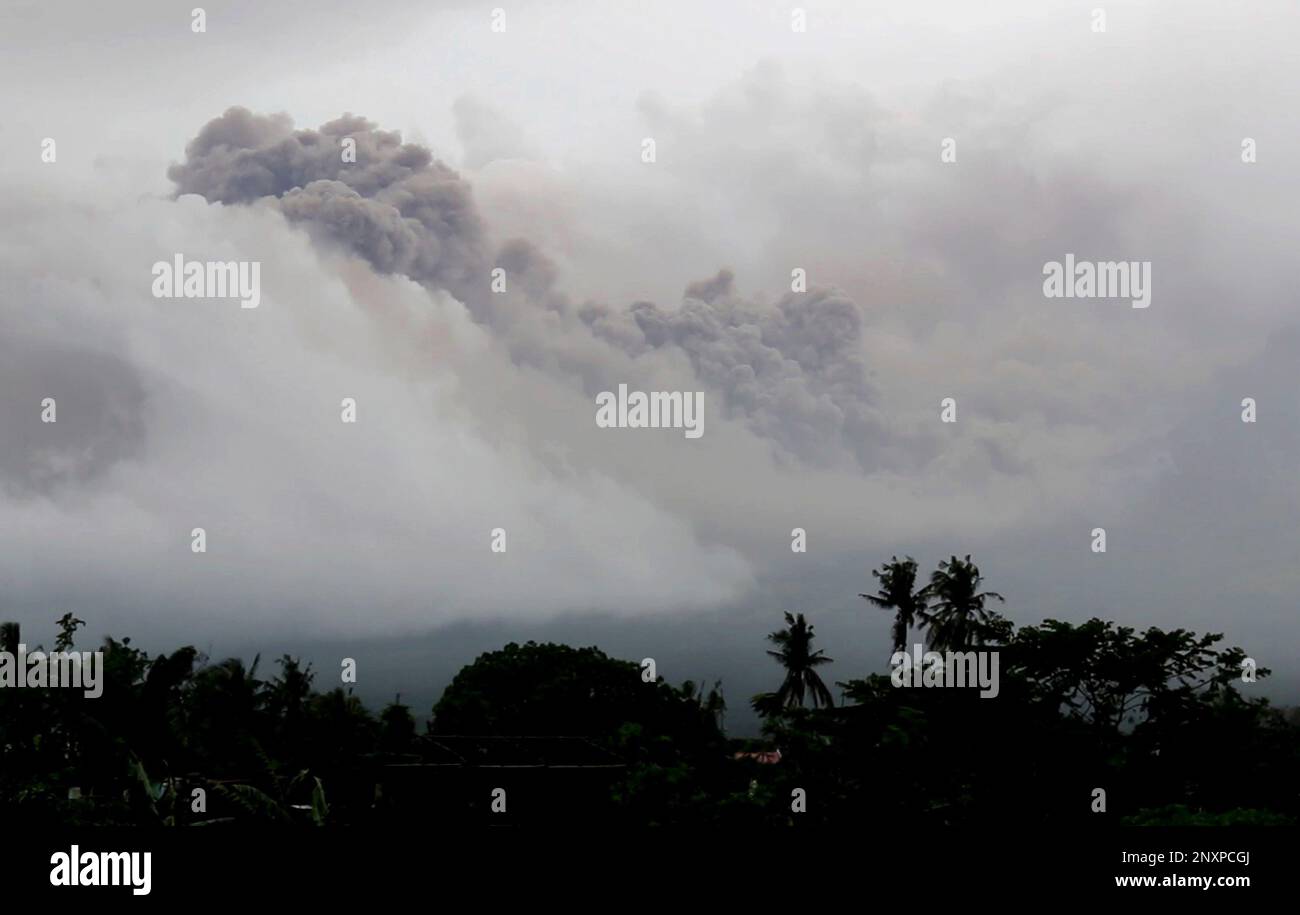 In this image made from video, dark pyroclastic ash cloud rises from ...