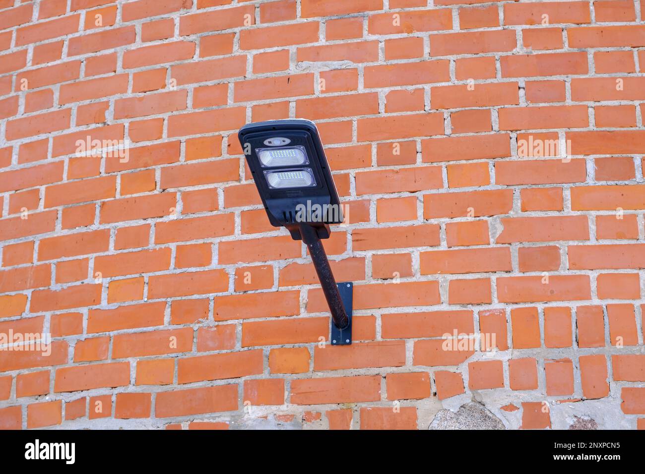 Lantern on the background of the old brick wall. A lamp on an ancient ...
